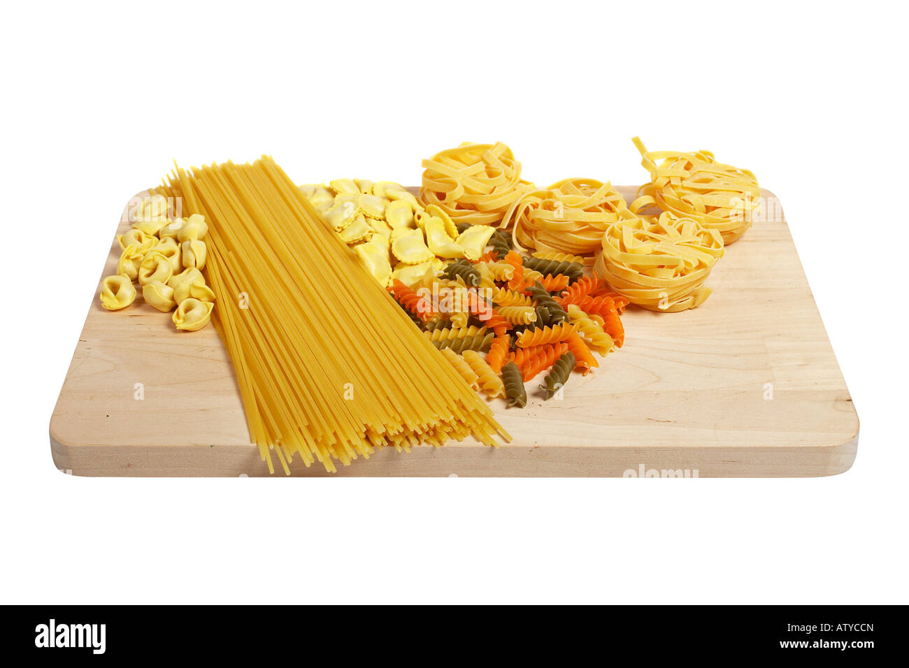 Set of uncooked pasta on wooden plate isolated on white background ...