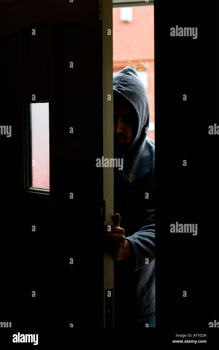 Burglar breaking into house Stock Photo - Alamy