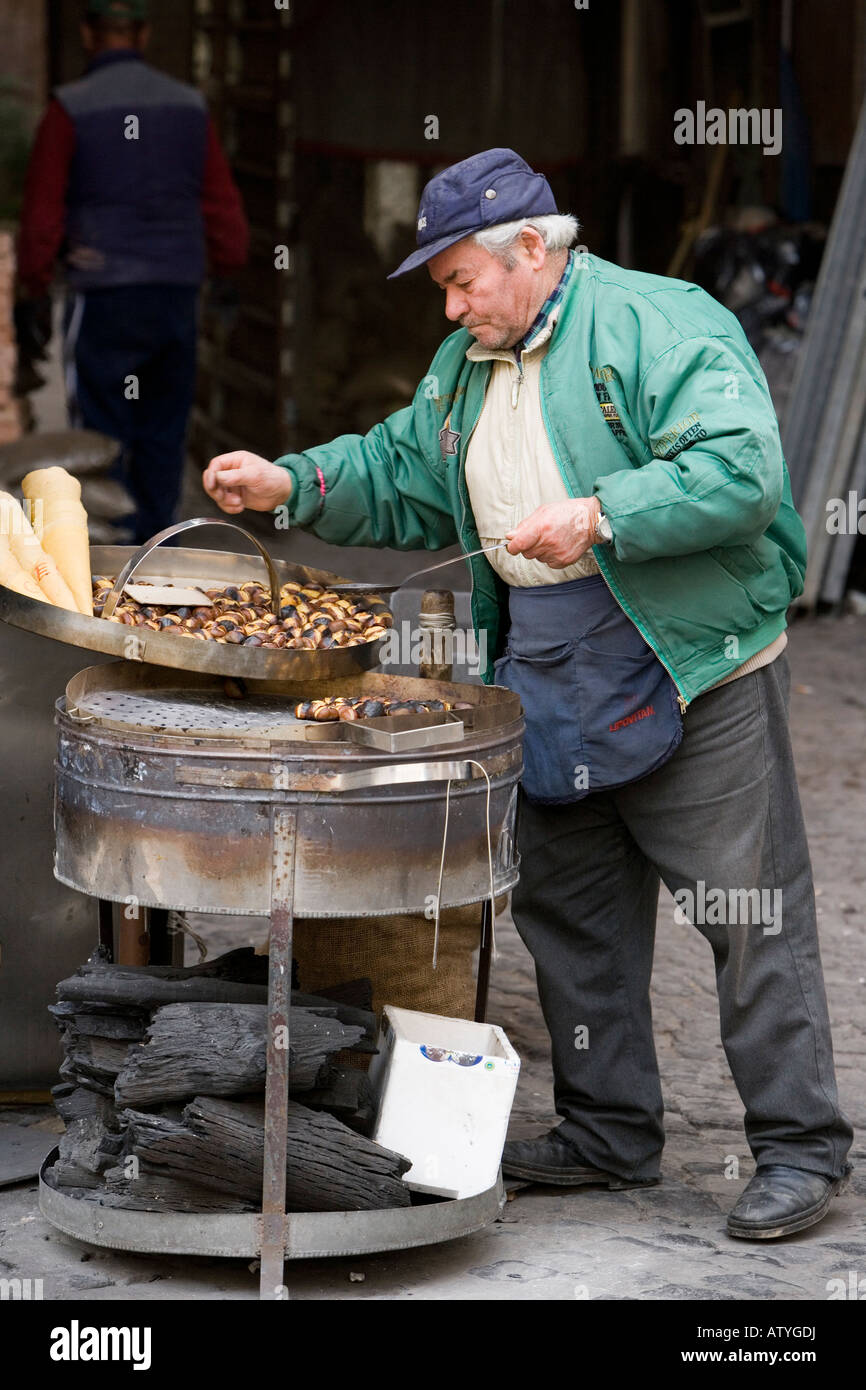 Man roasting chestnuts, Rome. Italy Stock Photo - Alamy