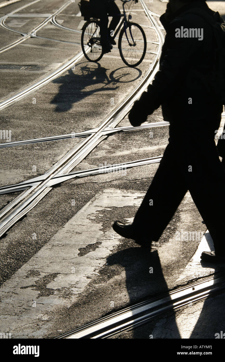 cyclist crossing tram lines in city Stock Photo - Alamy