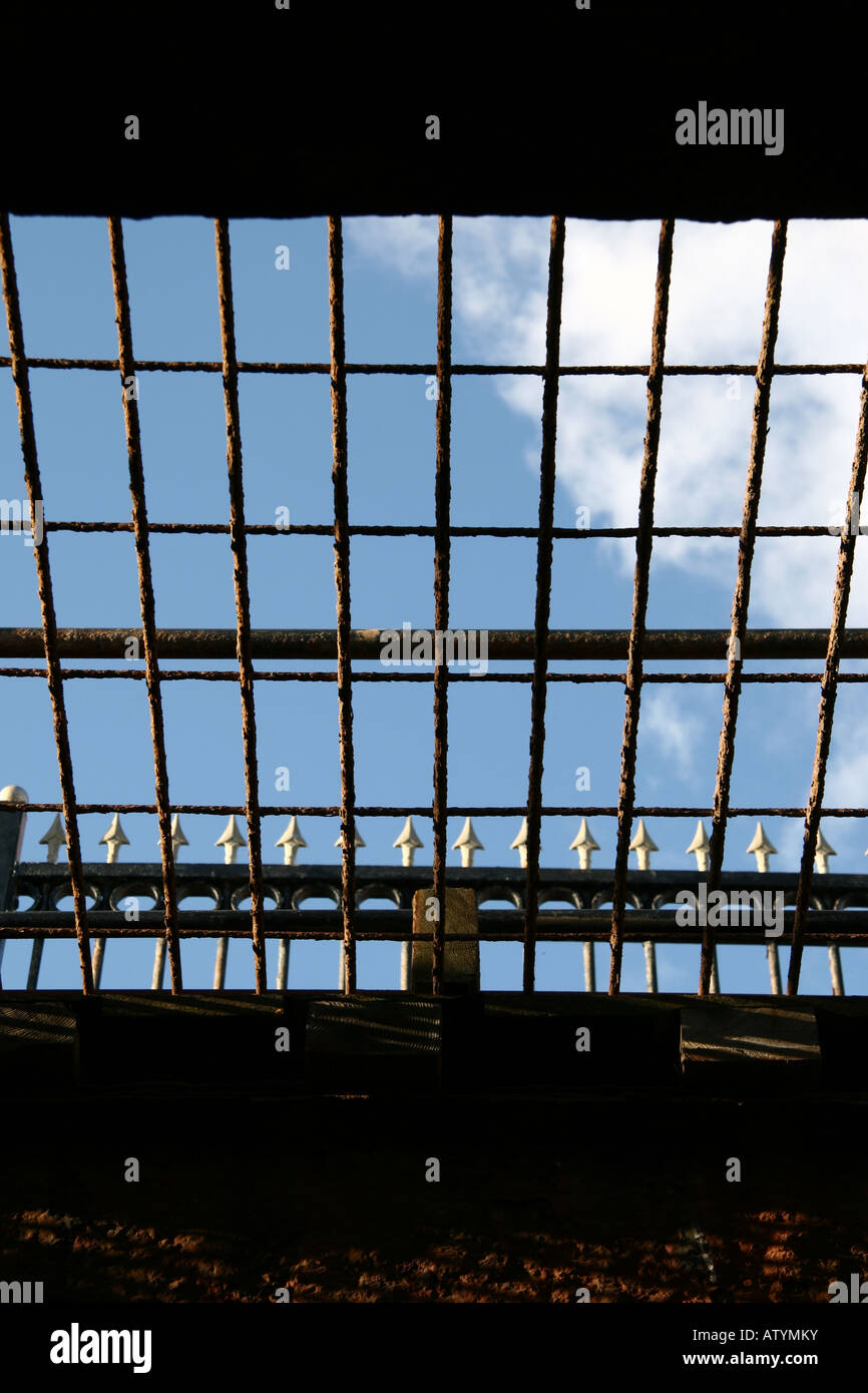 Looking up through a grating at a blue sky with white clouds Stock ...