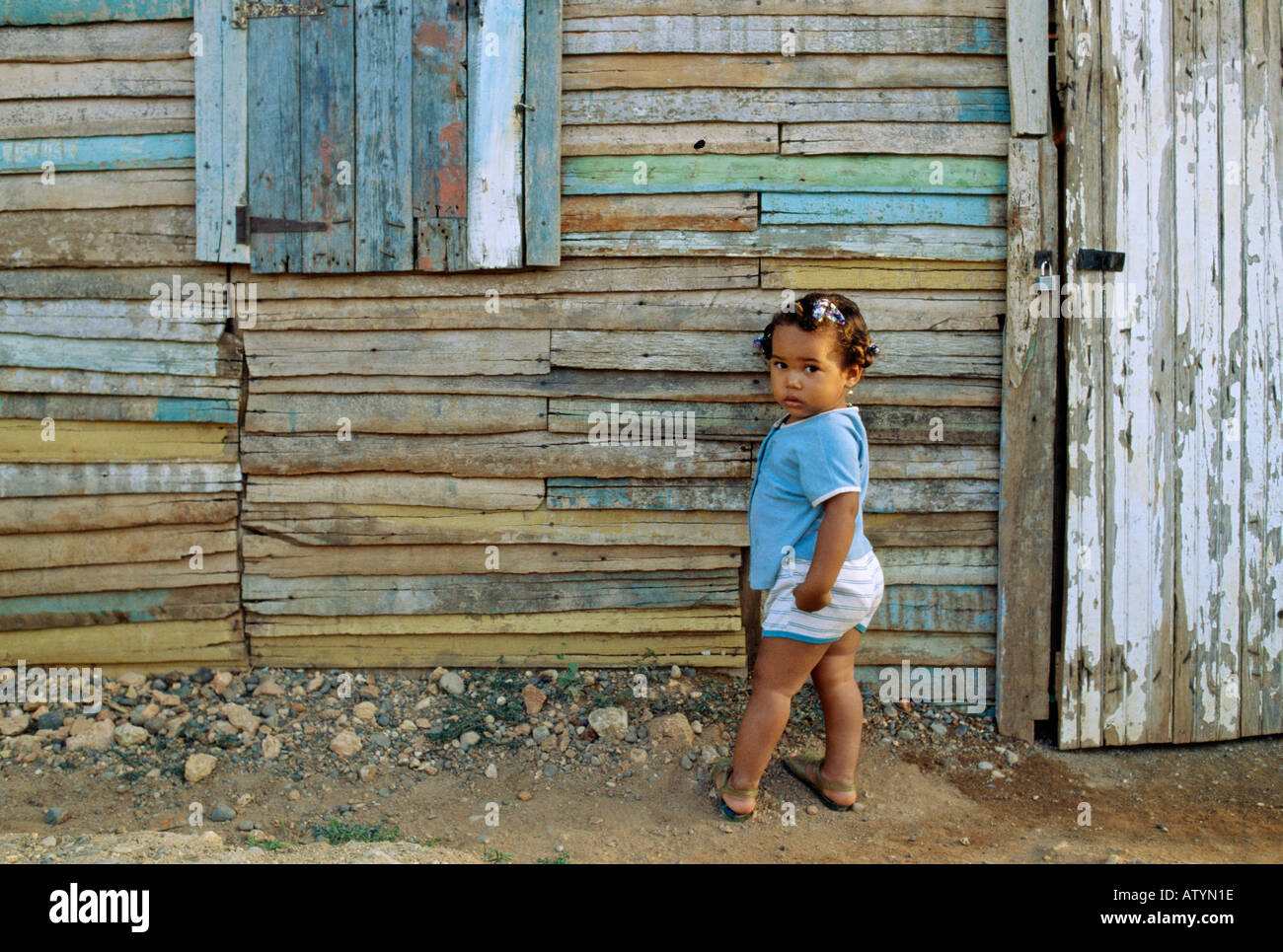 Portrait of a Dominican child outside a home in El Castillo Dominican ...