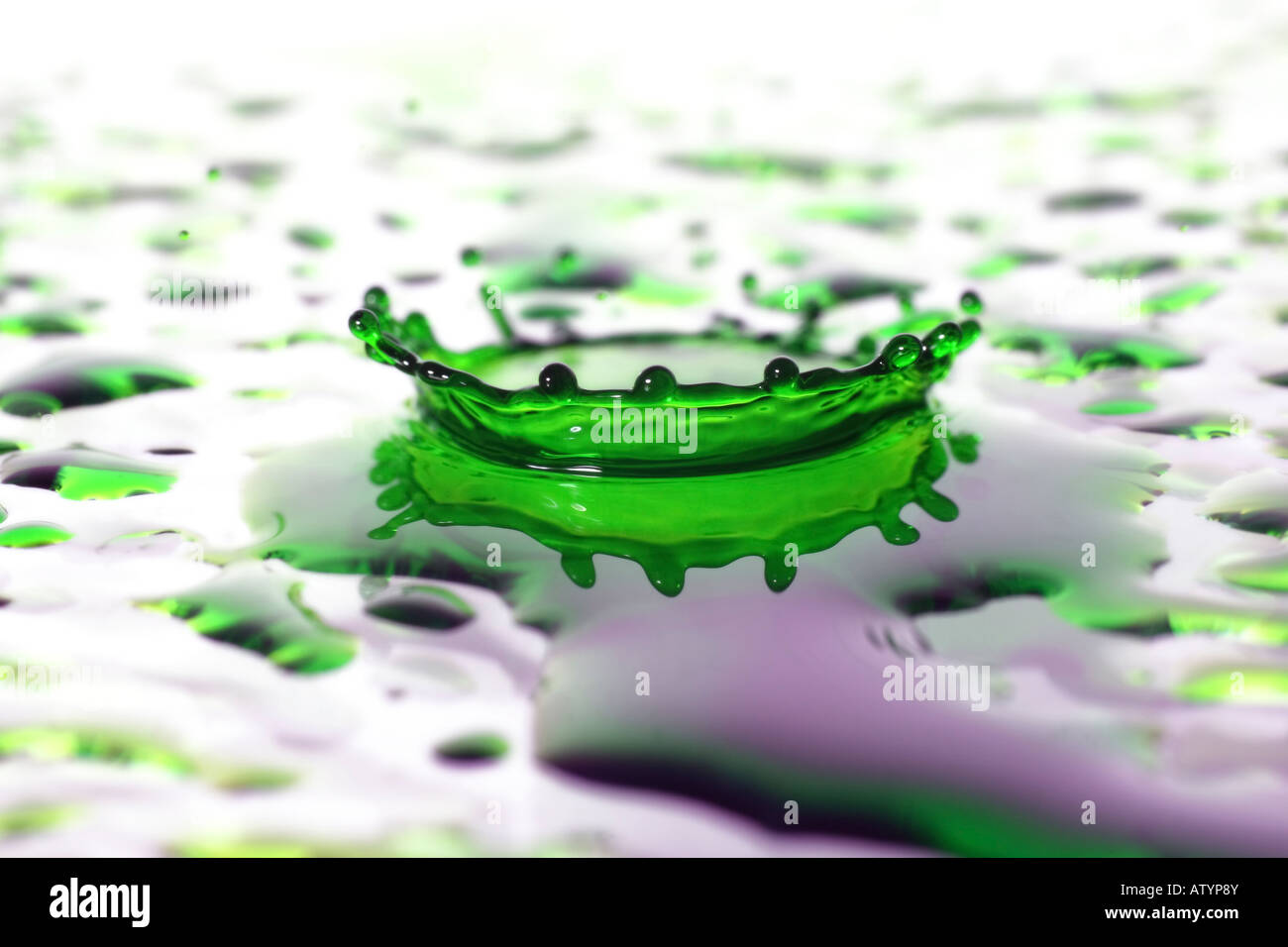 coloured water droplet splashing onto a surface Stock Photo - Alamy