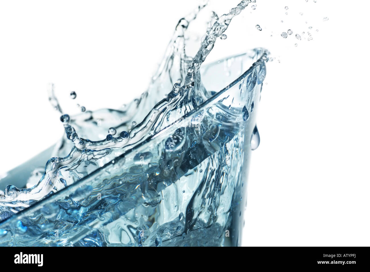 drinking glass with clear fluid splashing out and around Stock Photo ...