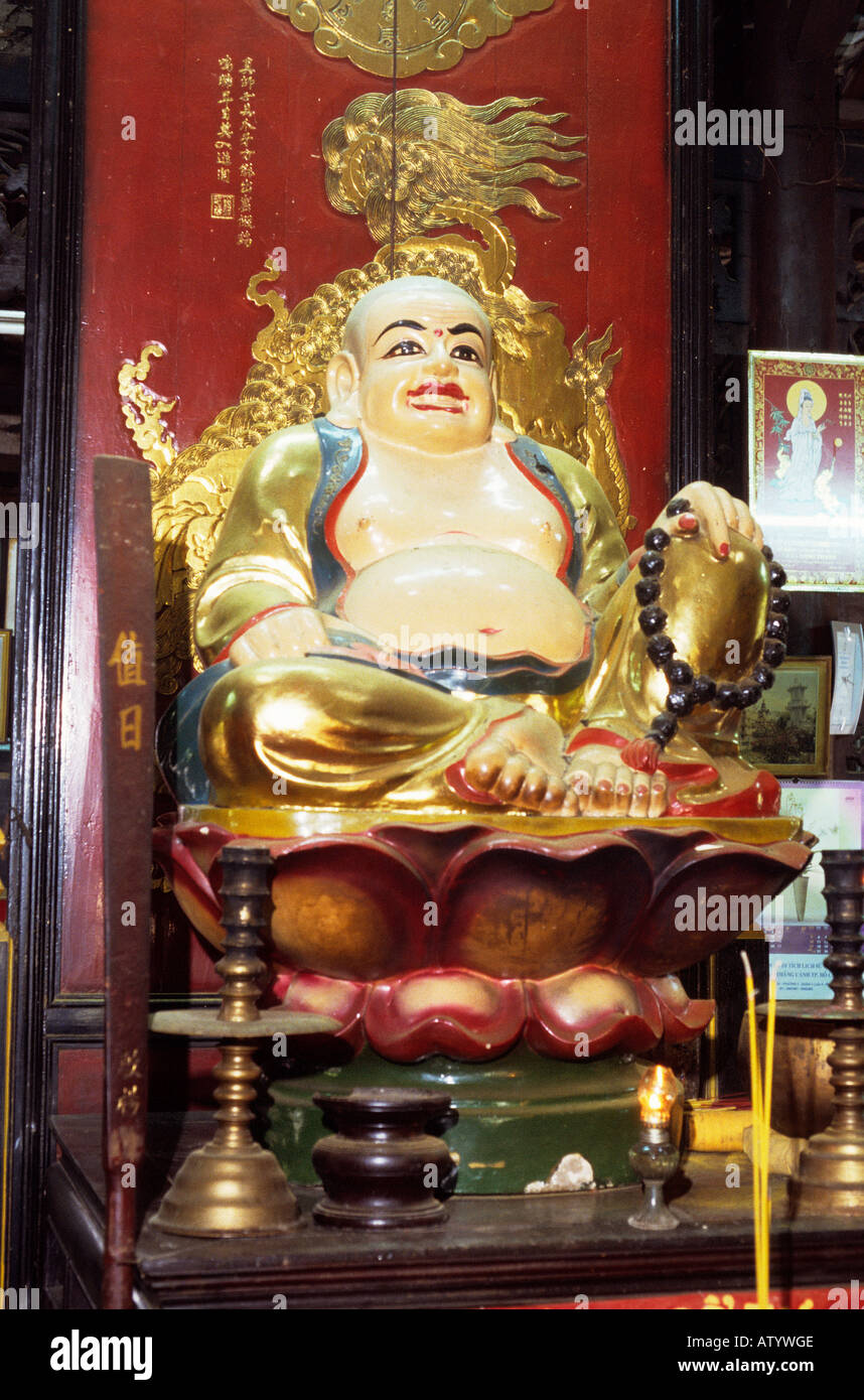A large buddha brightly painted inside the Phung Son Pagoda Cholon ...