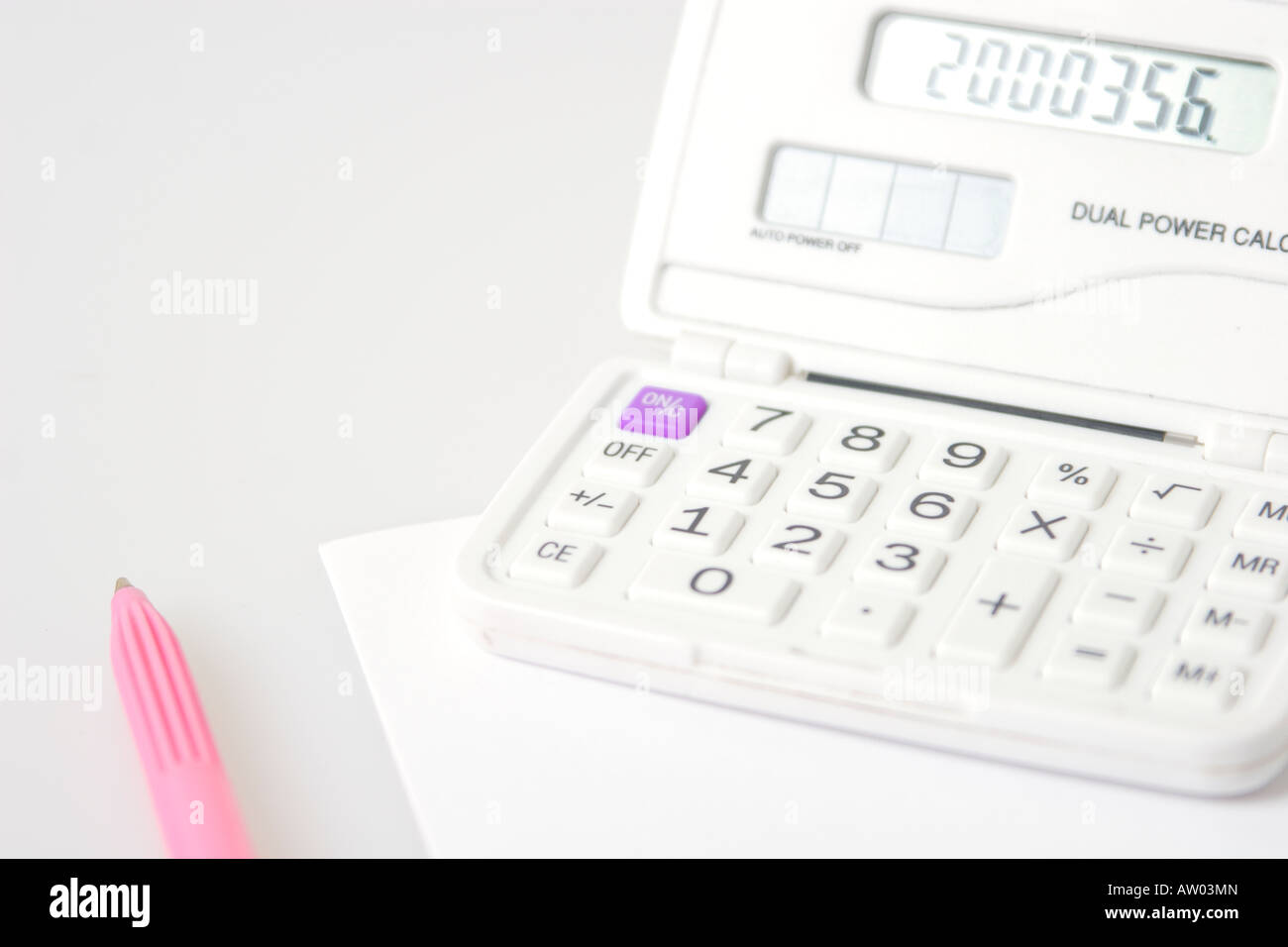 pink pen piece of paper and a calculator Stock Photo - Alamy