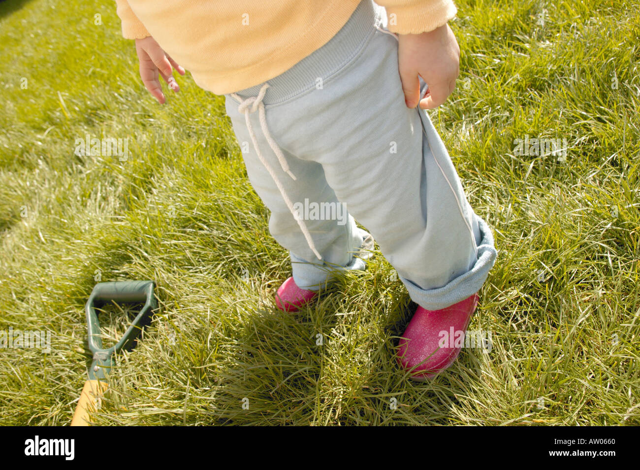 Child in the garden with spade Stock Photo - Alamy