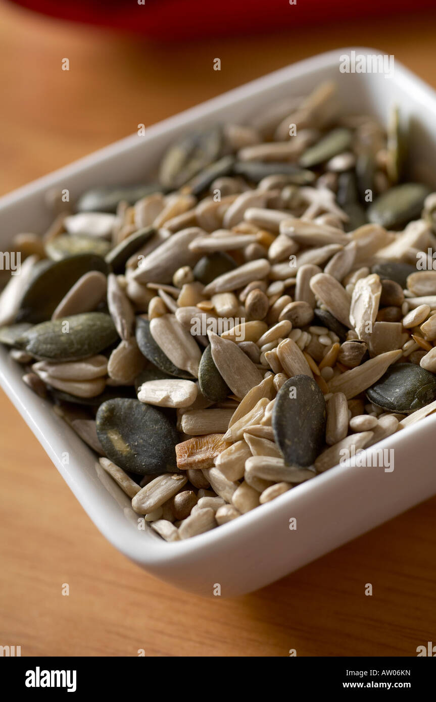 Mixed seeds pumpkin sunflower hemp millet linseed in dish close up ...