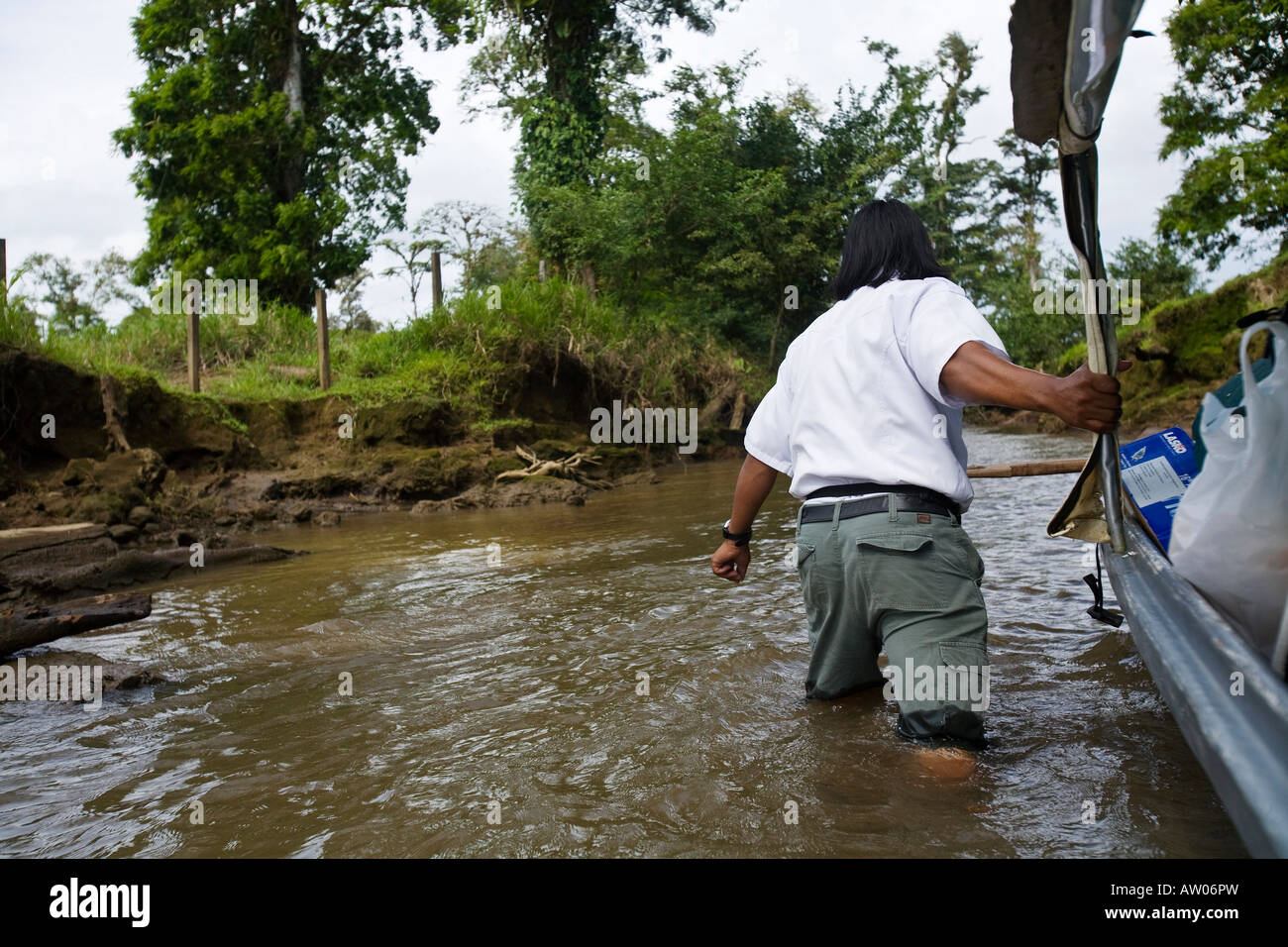 A boat man pulls the boat through the narrow man made canals that act ...