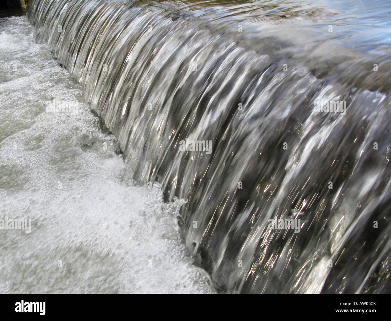 Flood water flowing over a normally dry weir Stock Photo - Alamy