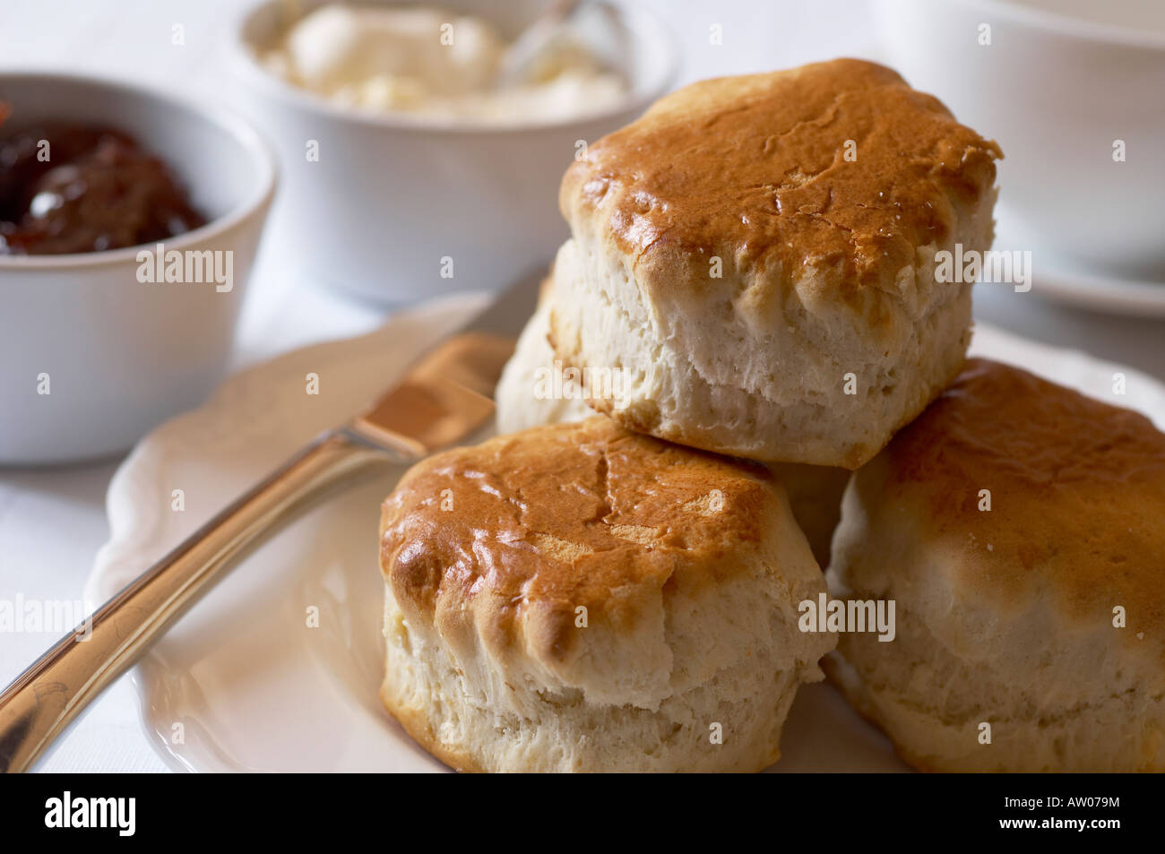 Plate of Scones on table set for tea Stock Photo - Alamy