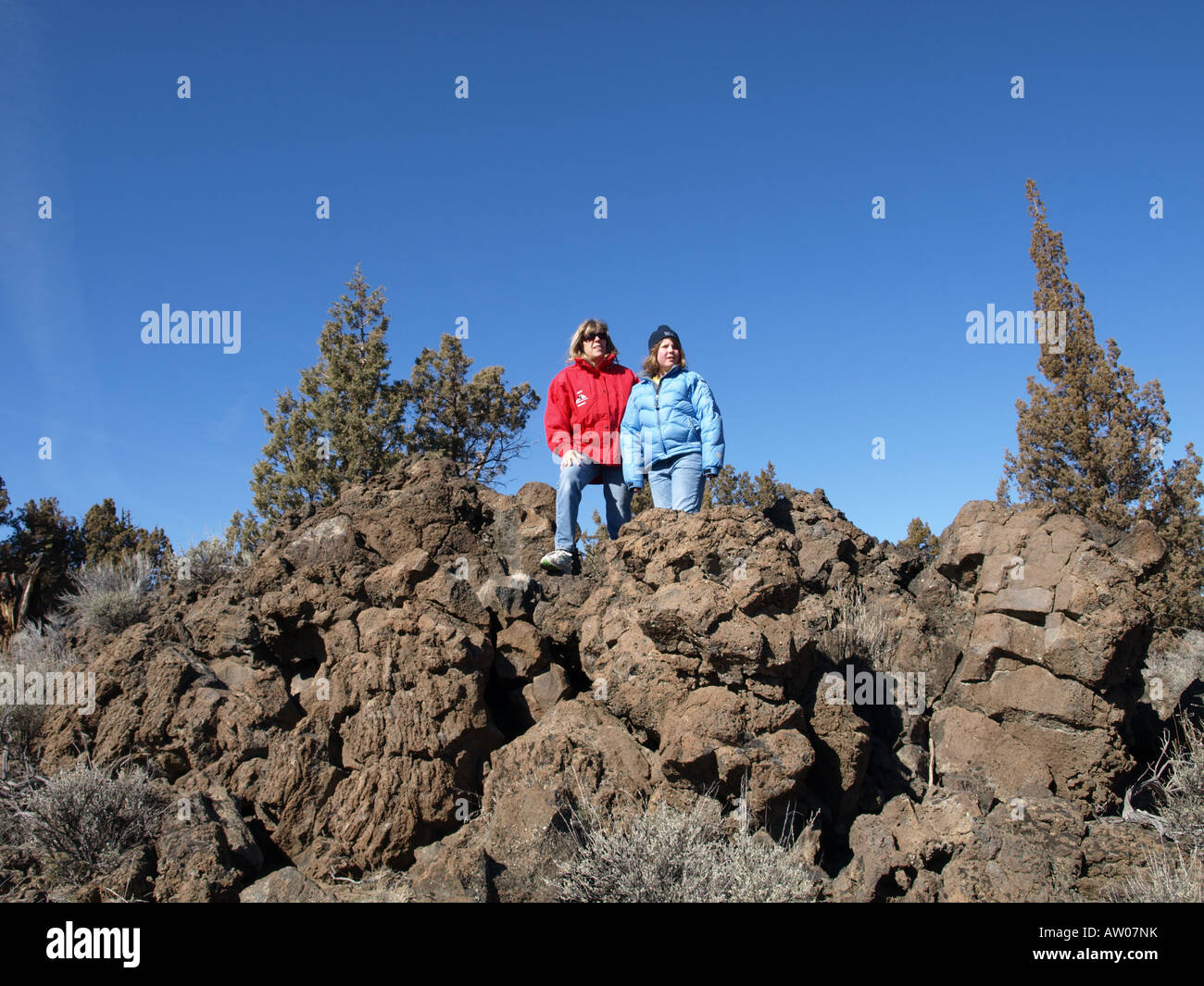 Hikers on a lava flow in the Badlands Wilderness Study Area east of ...