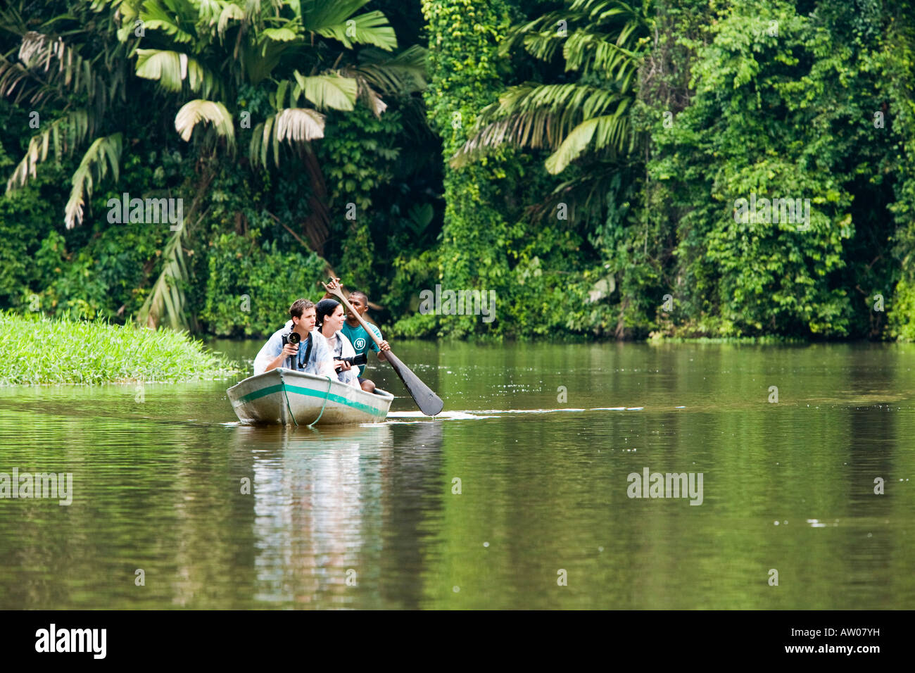 Tourists take an early morning tour of Tortuguero National Park in ...