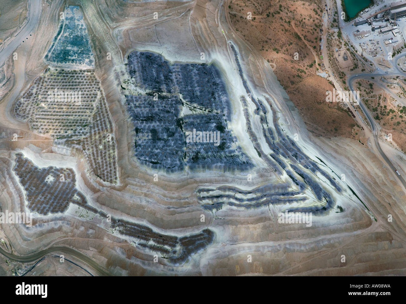 aerial view of geometric patterns of copper ore extraction and ...