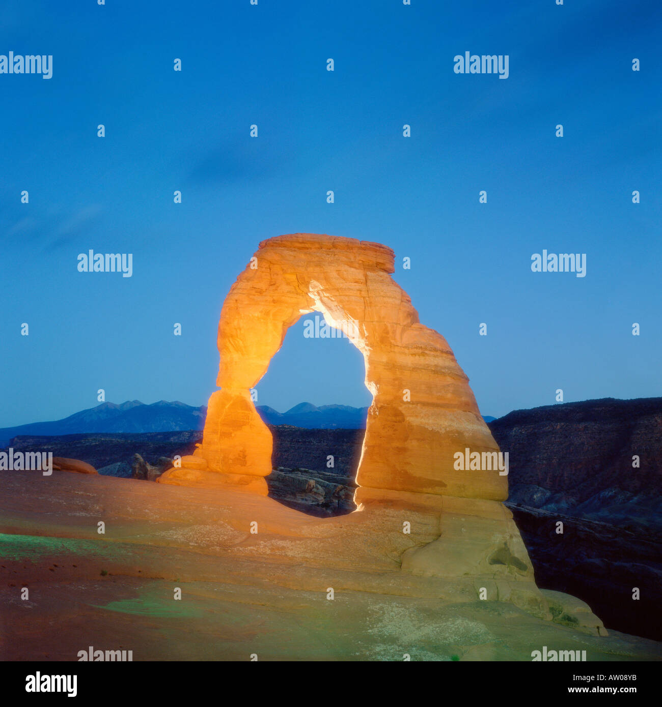 Surreal lighting on iconic natural sandstone arch in southwestern U S ...