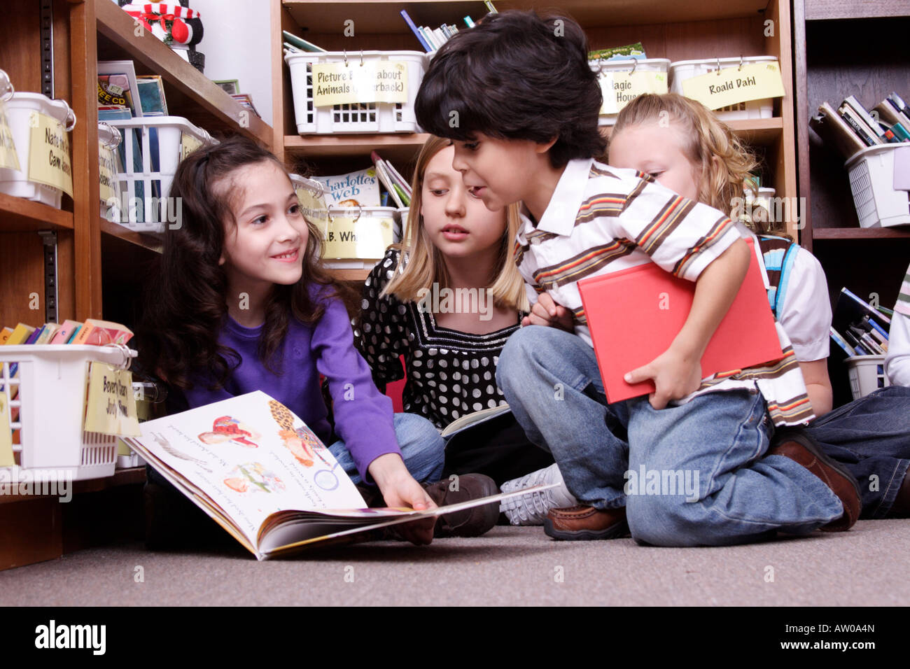 Stock Photograph of young students excited about books Stock Photo - Alamy