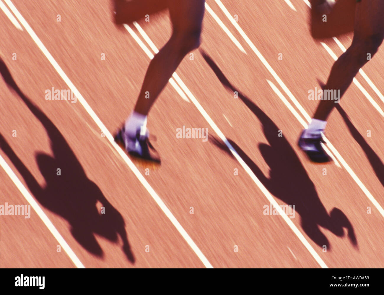Two sprinter s legs running side by side on a track Stock Photo - Alamy
