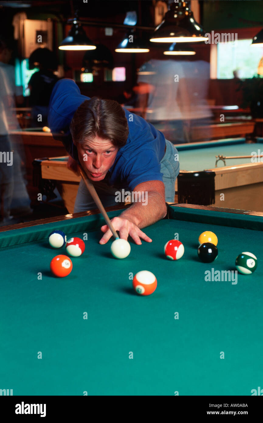 Man playing 8 ball in pool hall Stock Photo - Alamy