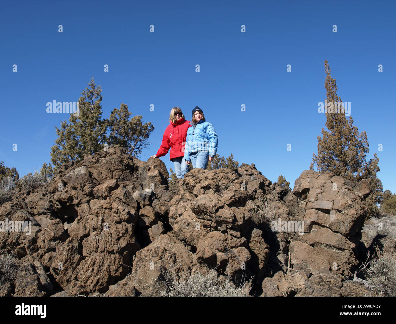 Hikers on a lava flow in the Badlands Wilderness Study Area east of ...