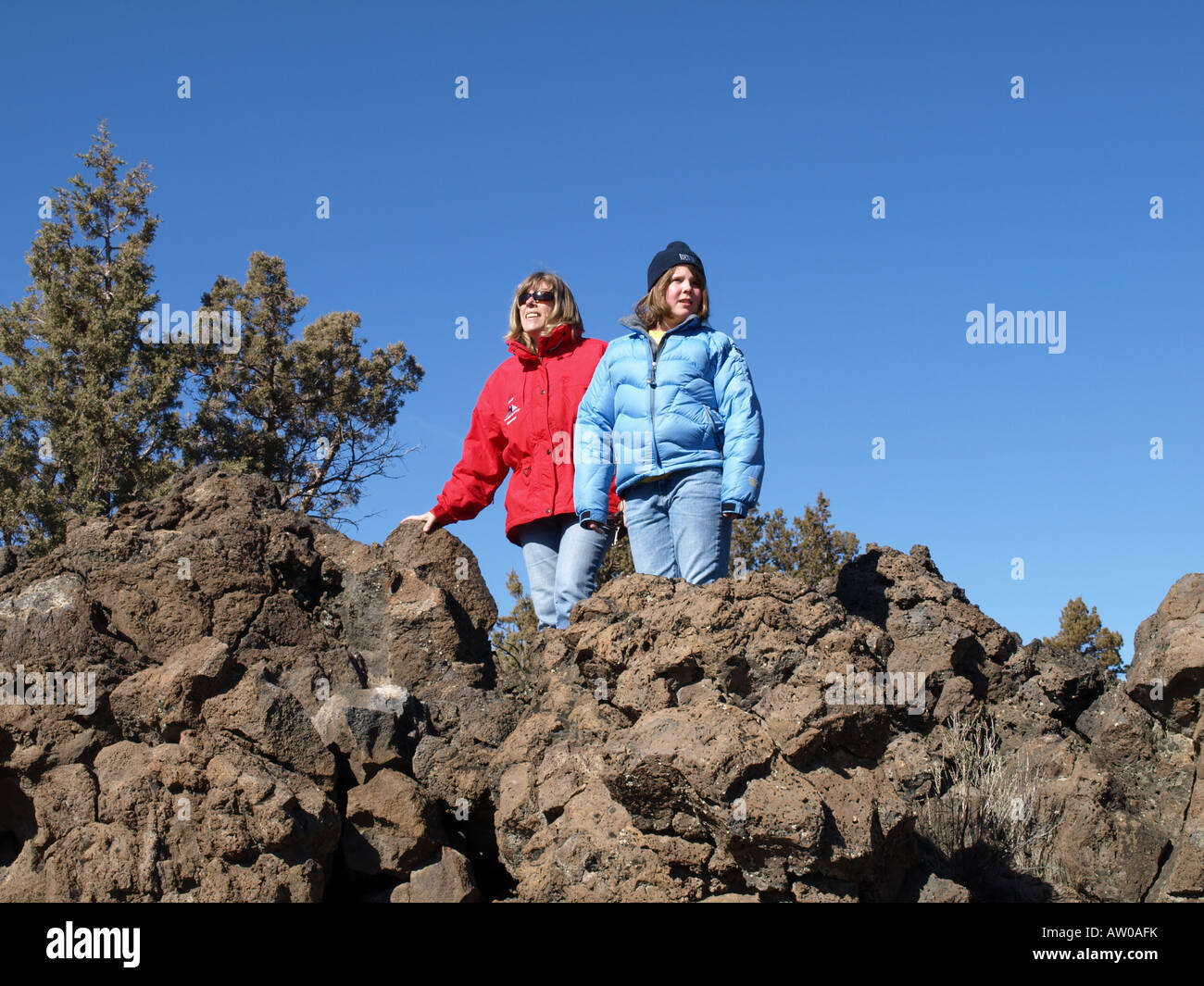 Hikers on a lava flow in the Badlands Wilderness Study Area east of ...
