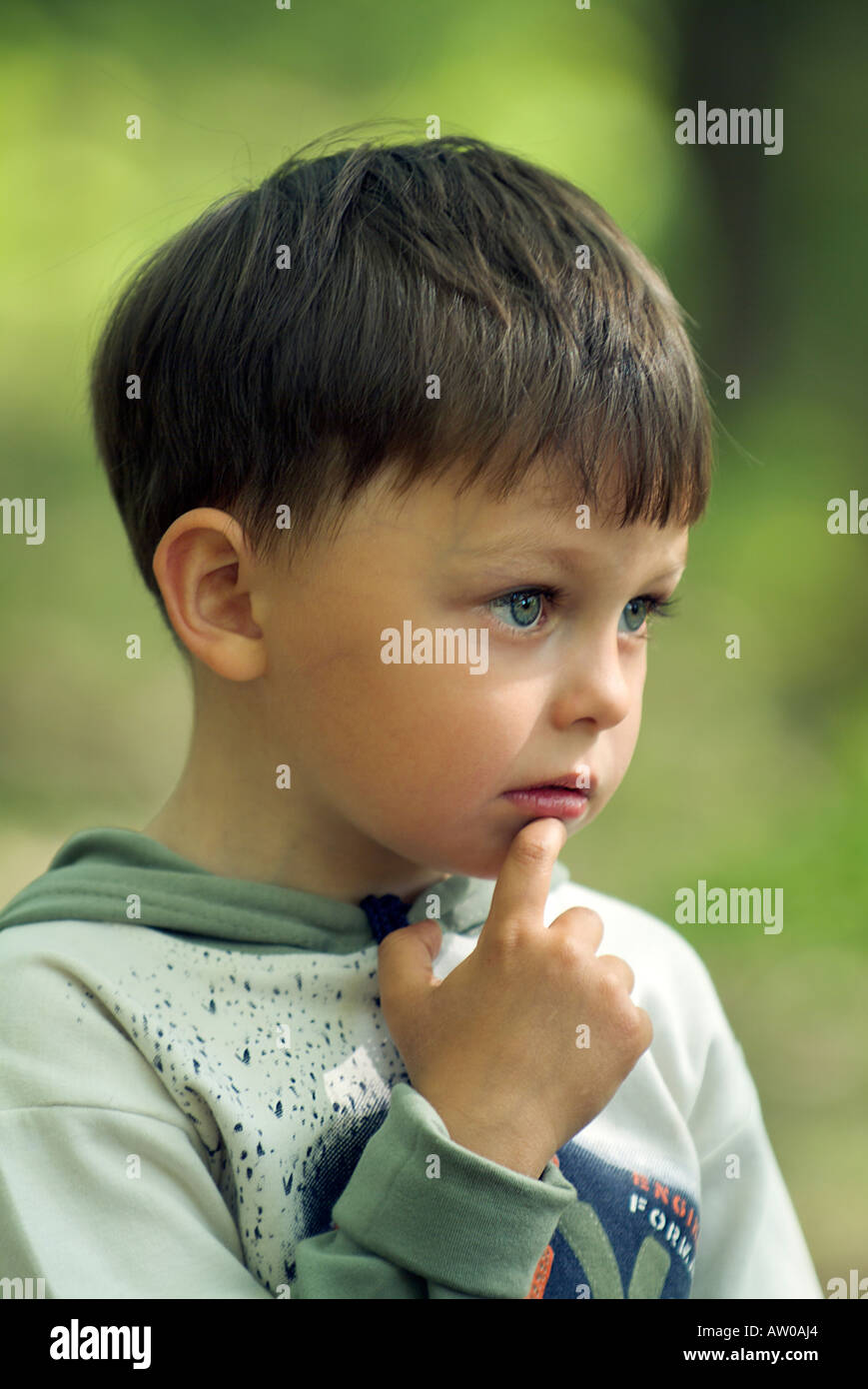 portrait of young boy looking worried Stock Photo - Alamy