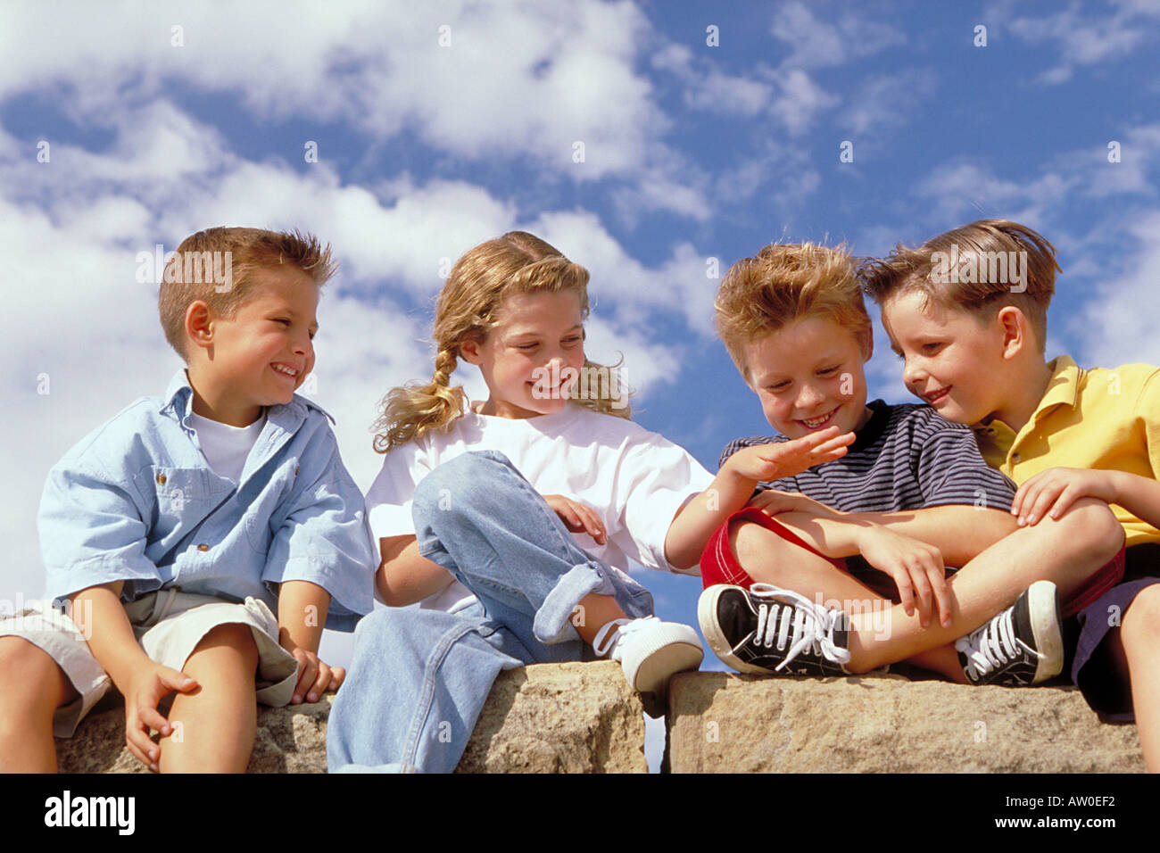 portrait of a group of kids sitting on a mural Stock Photo - Alamy