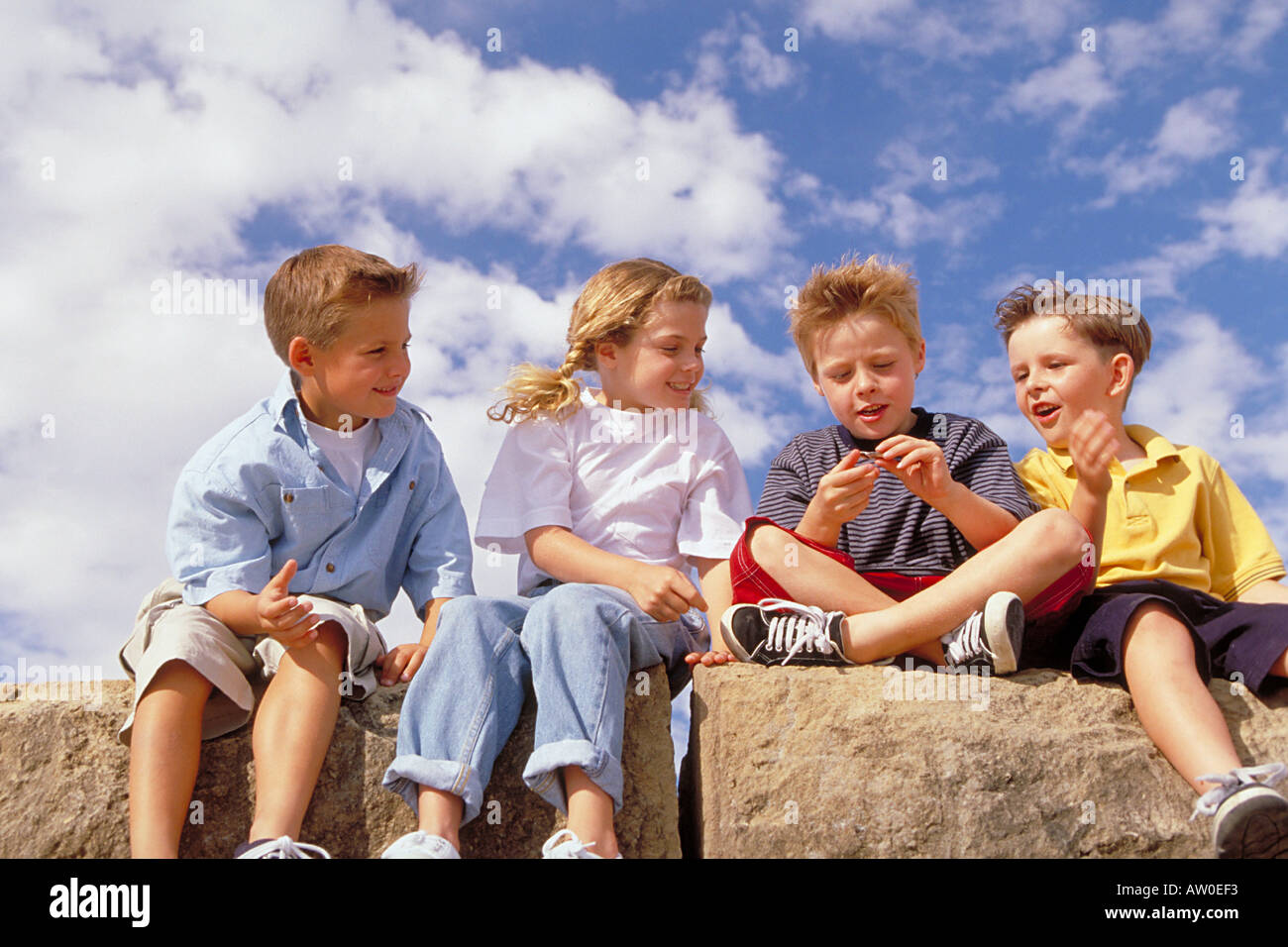 portrait of a group of kids sitting on a mural Stock Photo - Alamy