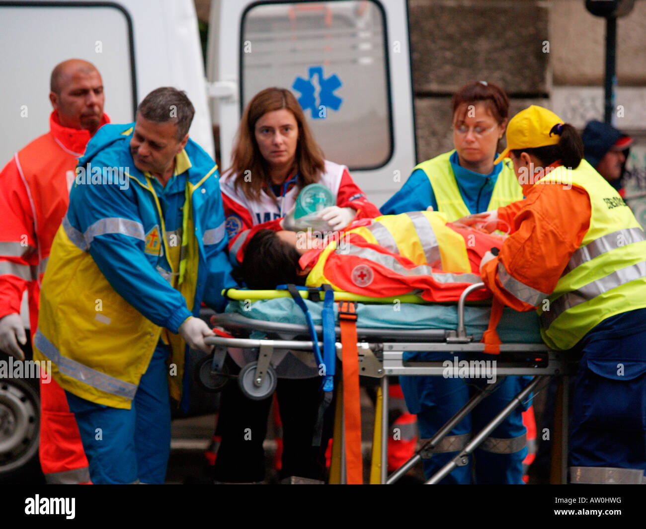 paramedics take fake casualty on stretcher to ambulance during a ...