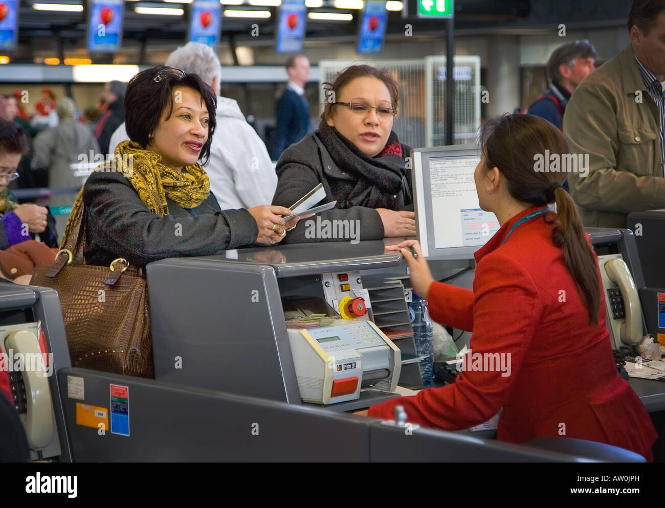Two women at the Airport Ticket Counter, Schiphol Airport, Netherlands ...