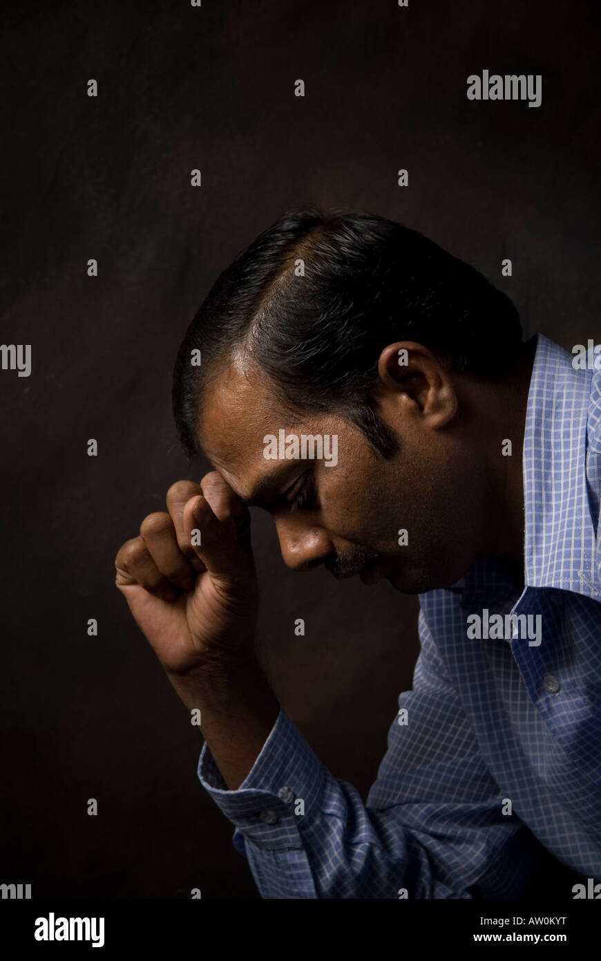 Indian man head in hands Stock Photo - Alamy
