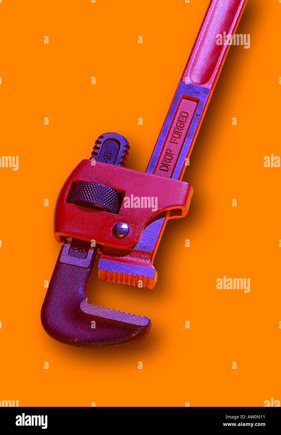 RED ADUSTABLE STEEL WRENCH ON YELLOW BACKGROUND Stock Photo - Alamy
