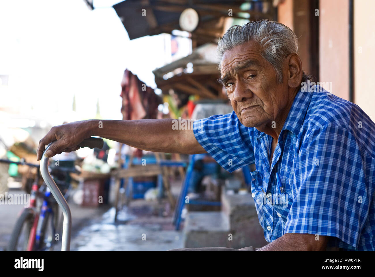 An old man gives the photographer a wry look as the camera is trained ...
