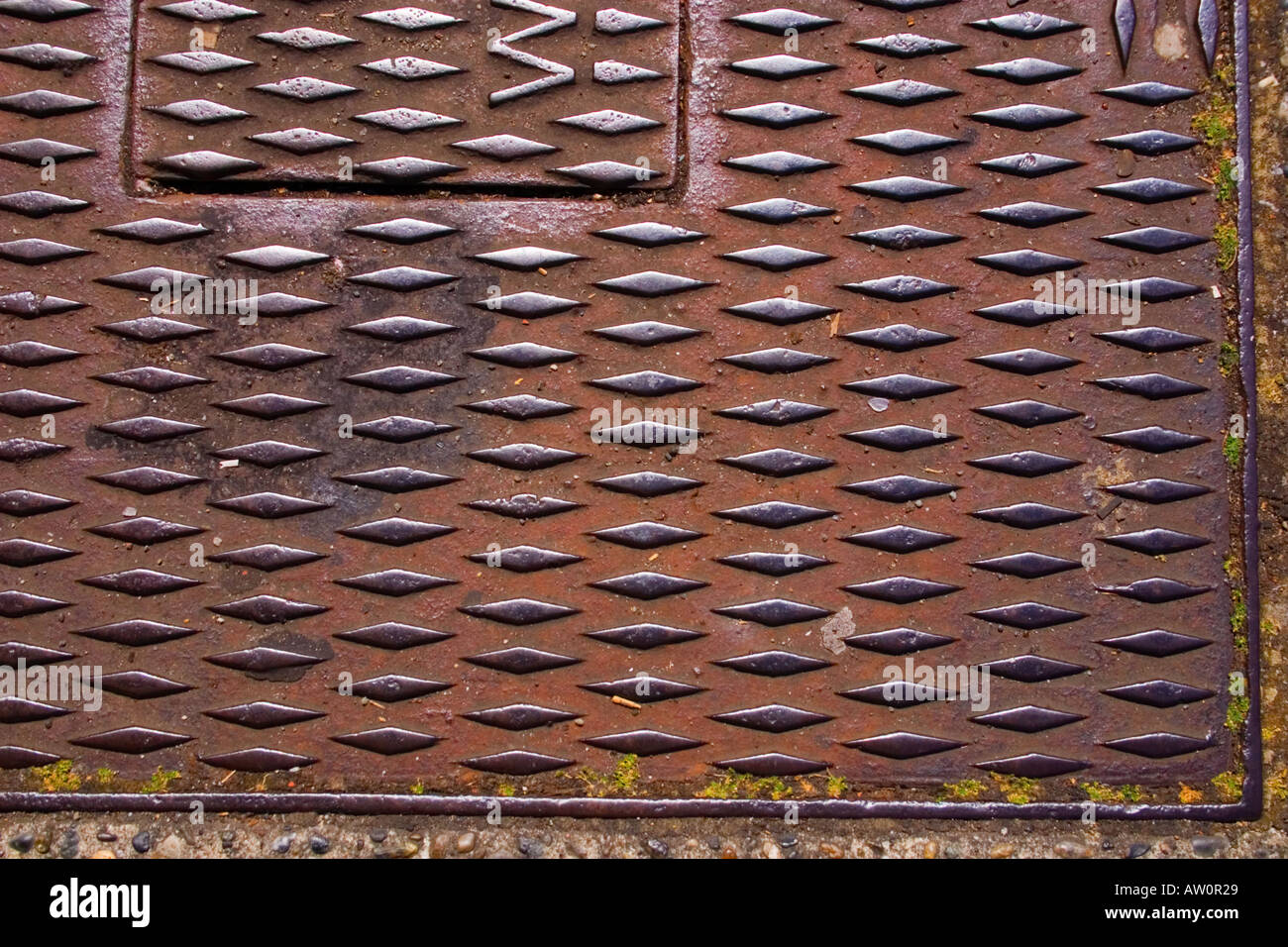 Metal grid with rusty diamond shapes worn from people walking on it ...