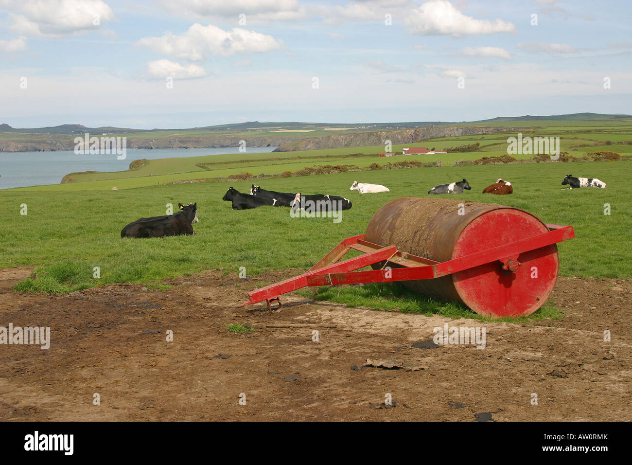 Red Roller Farm machinery on farmyard, Pembrokeshire, Wales Stock Photo ...
