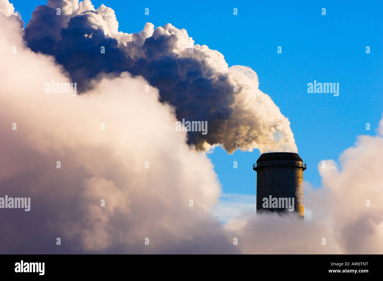 Steam rising from stack and cooling towers at nuclear power plant on ...