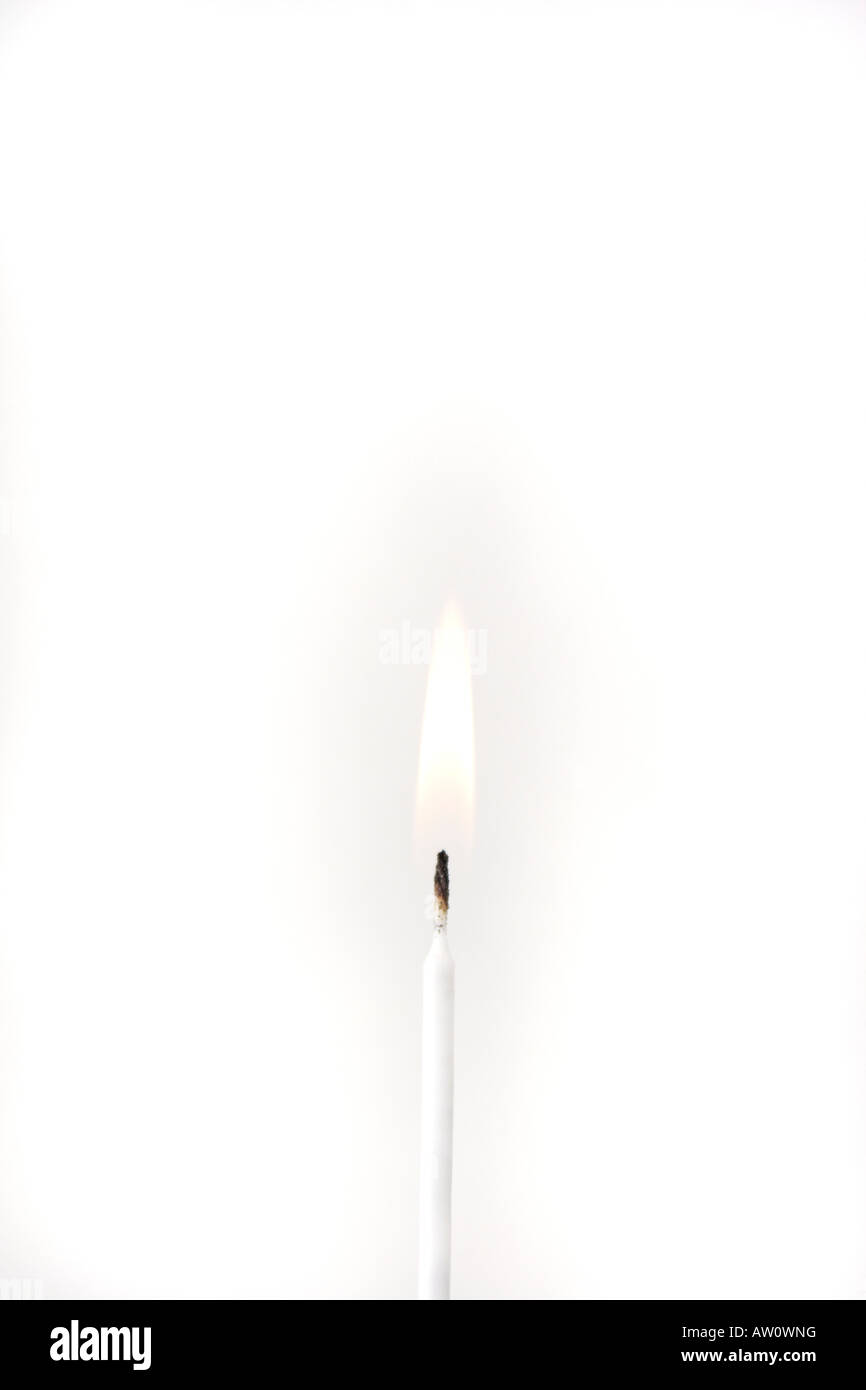 single white candle with flame Stock Photo - Alamy