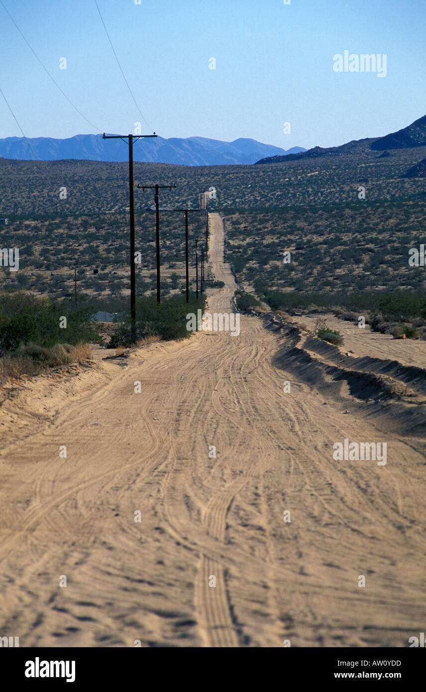 Empty desert road, telegraph poles and mountains, California Stock ...