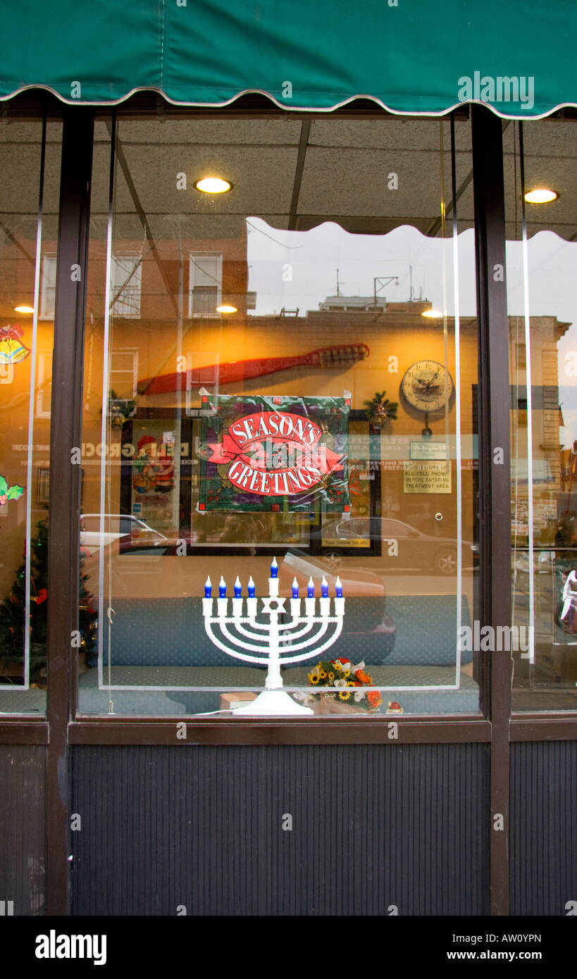 store window with slogan season's greetings and Jewish menorah ...