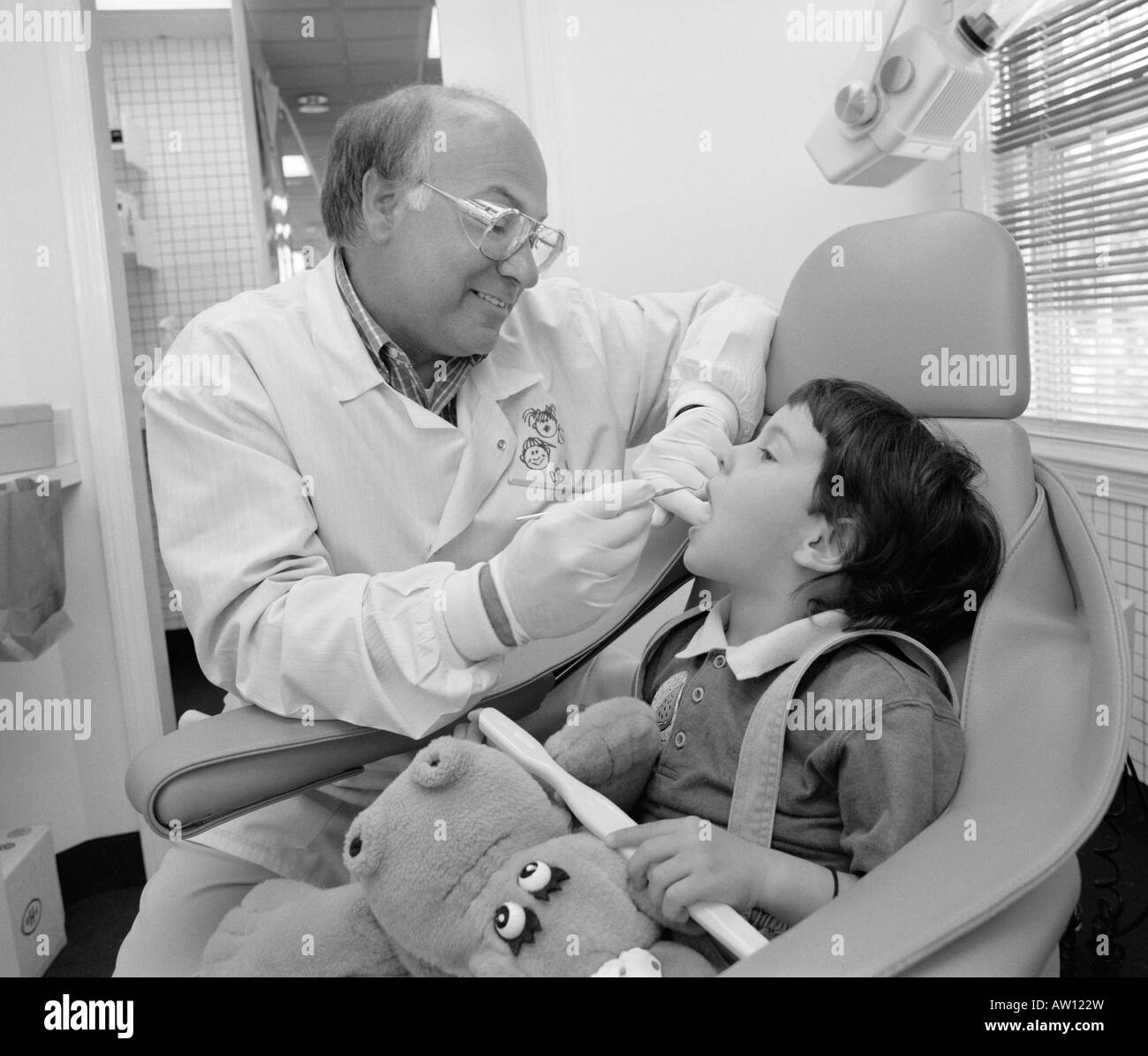 A little boy has his teeth checked during a trip to the dentist Stock ...