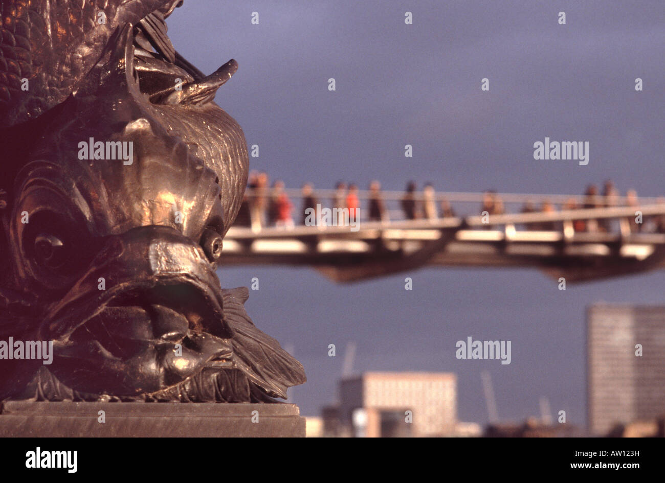 Sculpted dolphin lamp base beside River Thames with people on ...
