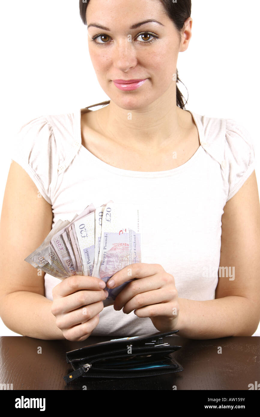 Young Woman Putting Money in Purse Model Released Stock Photo - Alamy