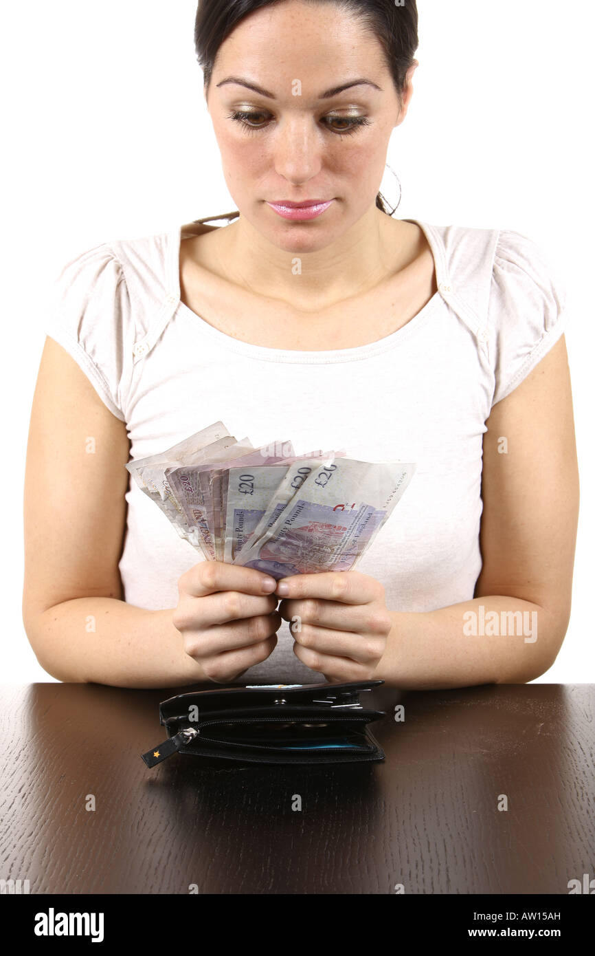 Young Woman Putting Money in Purse Model Released Stock Photo - Alamy