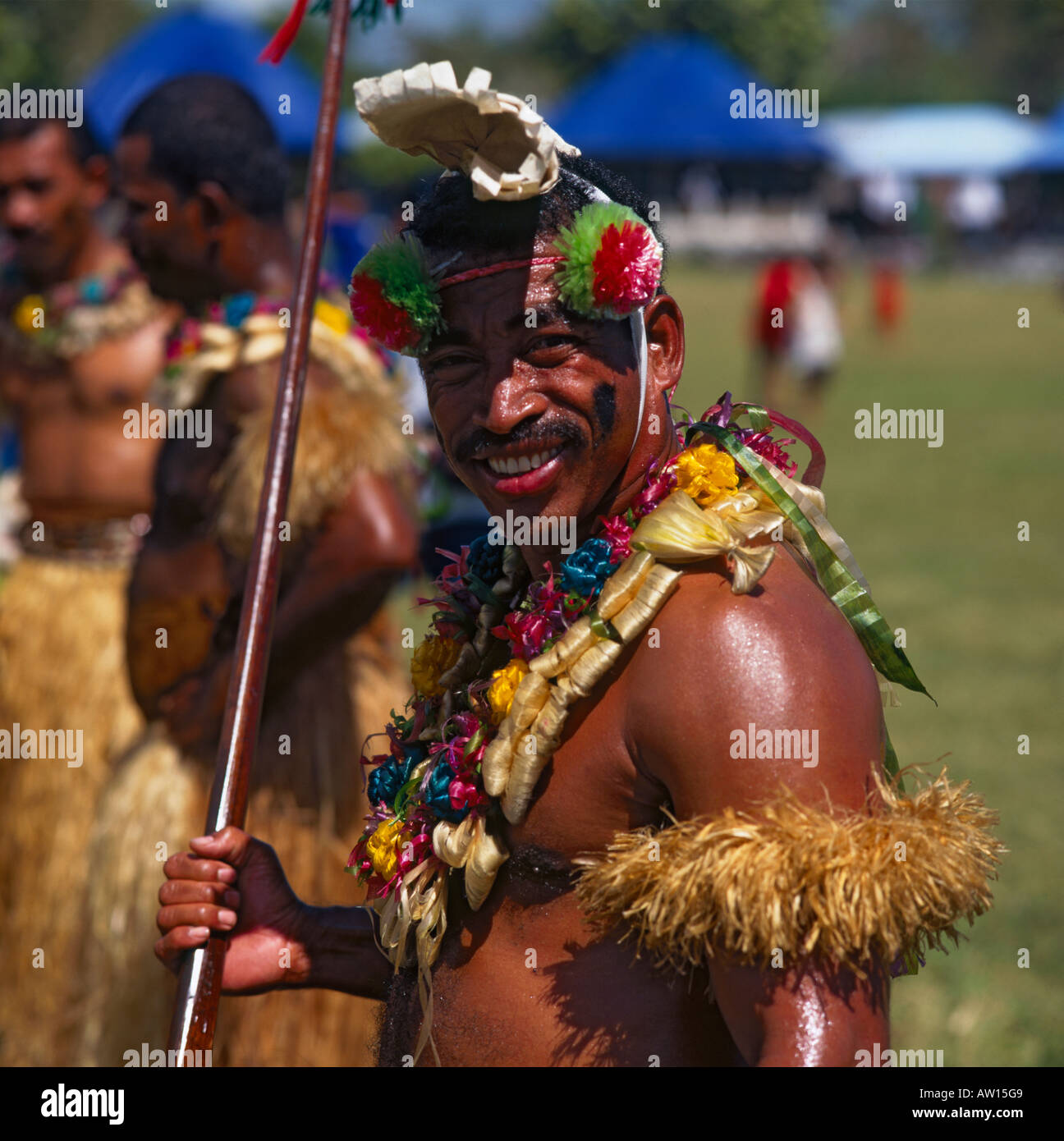 Portrait of a male Fijian dancer in colourful costume headdress ...
