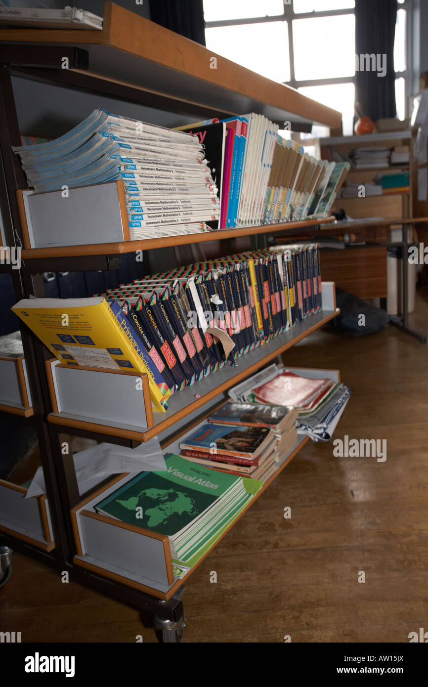 selection of primary school maths and english textbooks on a bookcase ...