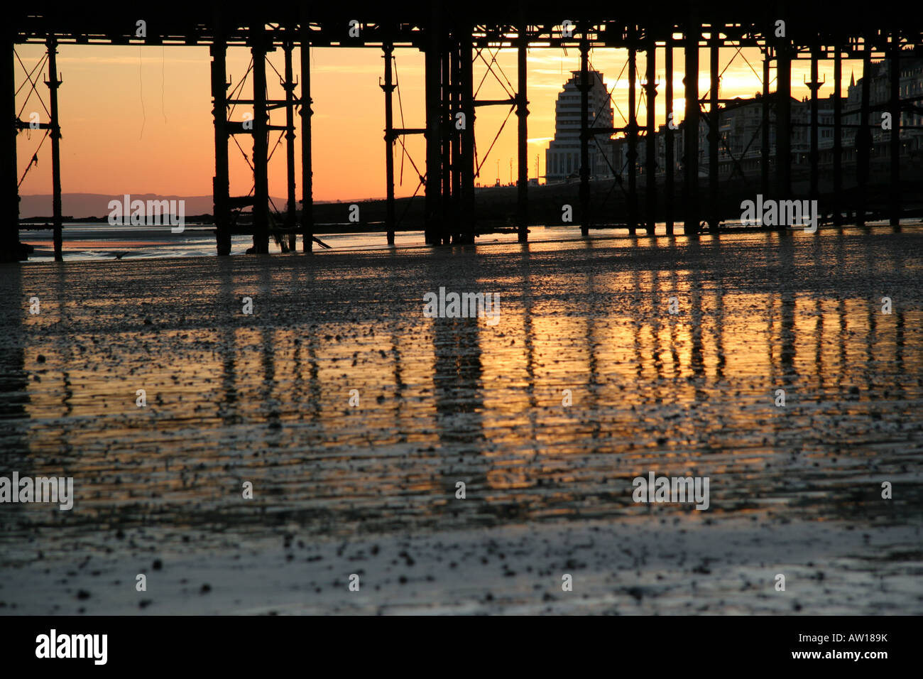 Looking under Hastings pier at sunset Stock Photo - Alamy