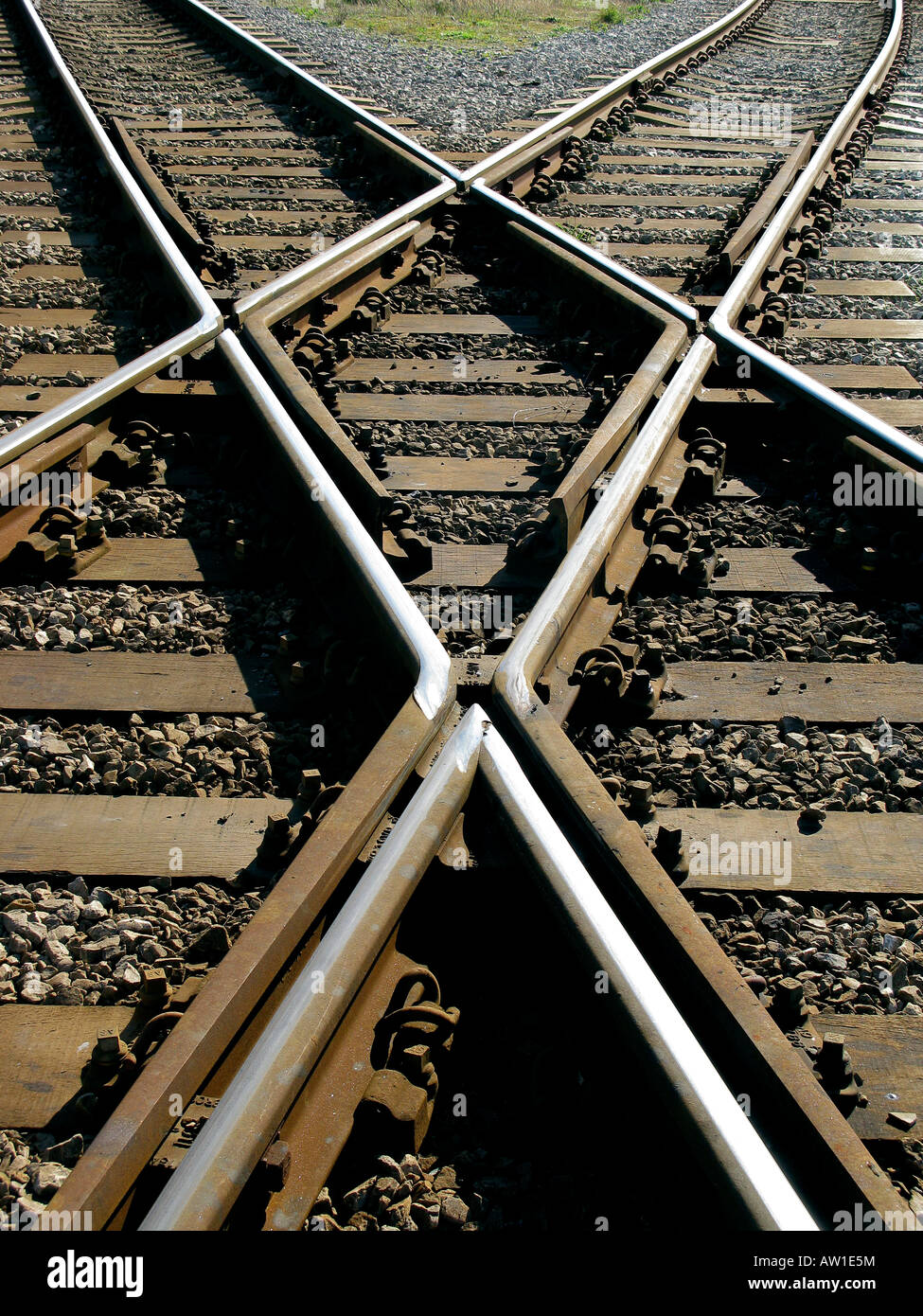two railway tracks cross at a junction Stock Photo - Alamy