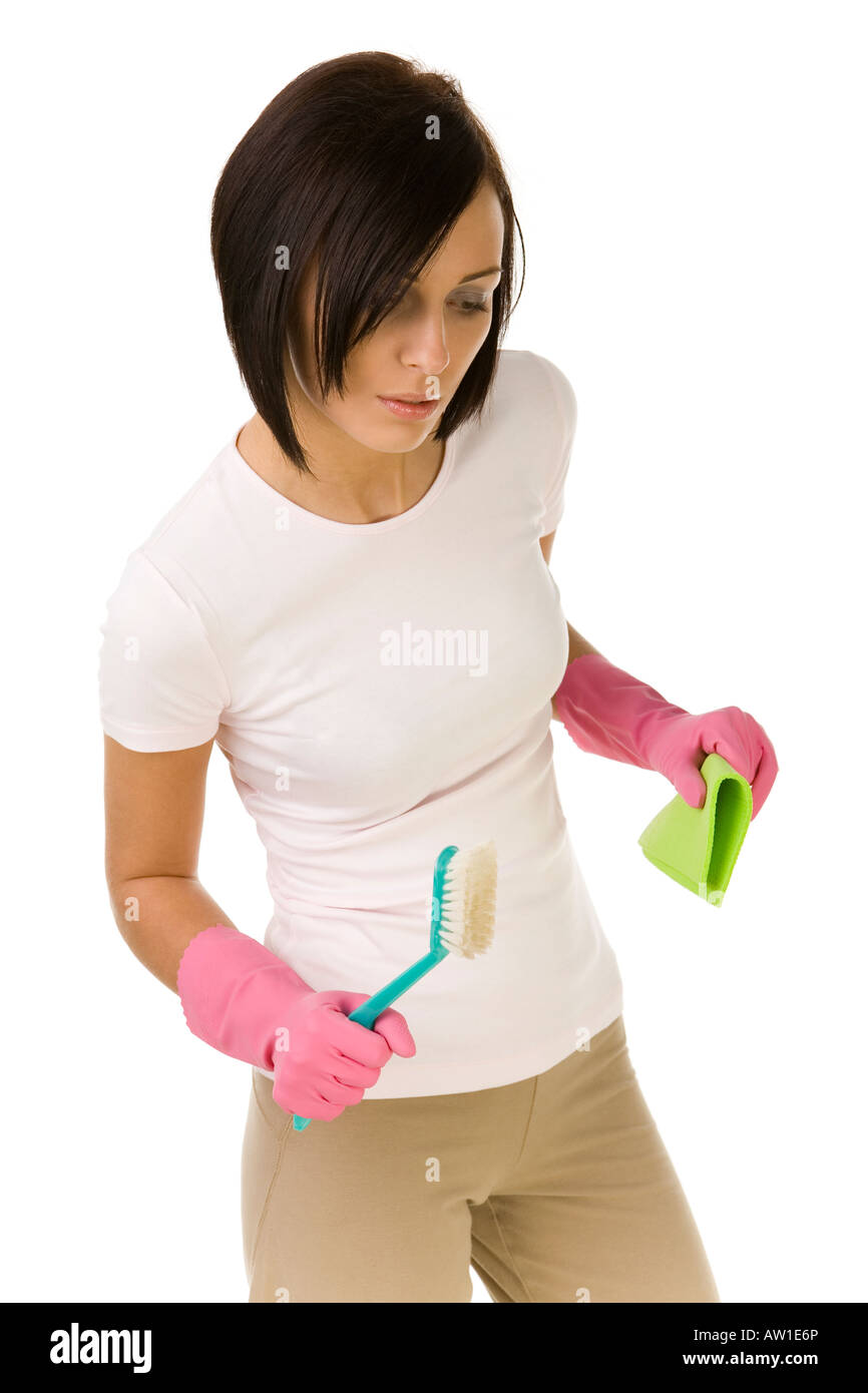 Young woman standing and holding in hands washcloth and scrubbing brush ...