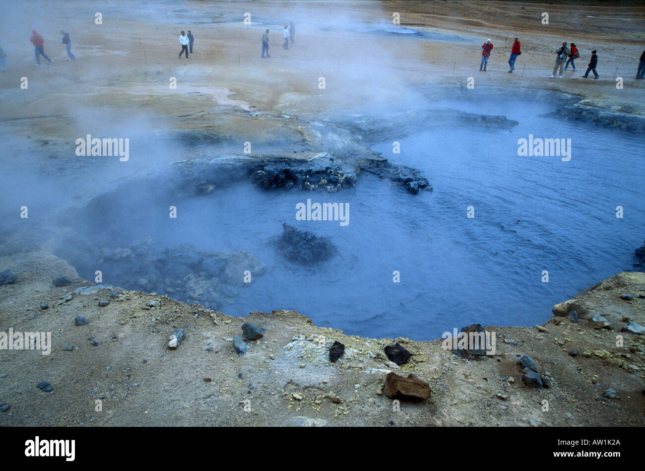 Tourist at bubbling hot geothermal mud pools, Iceland Stock Photo - Alamy