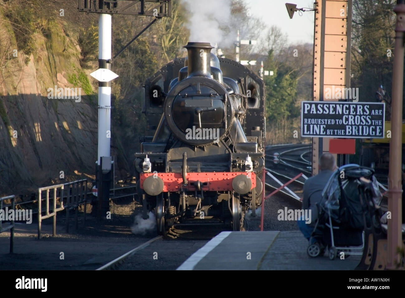A steam locomotive approaching a station Stock Photo - Alamy