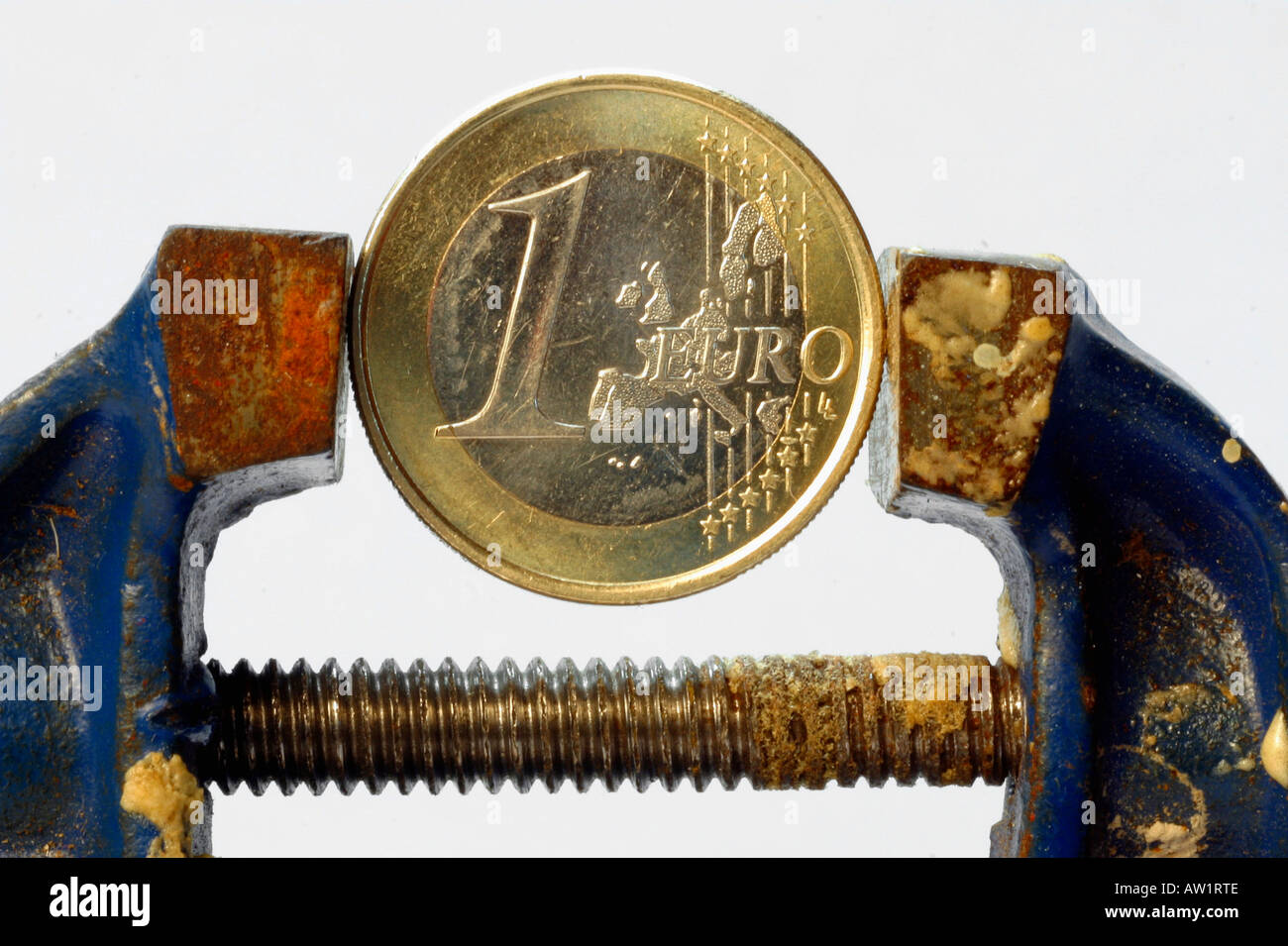 Euro in bench vice, coin Stock Photo - Alamy